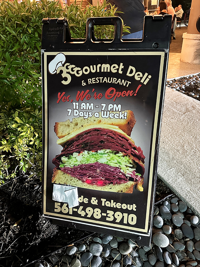 The sidewalk sign says it all—that sandwich isn't just stacked, it's architectural. A skyscraper of flavor that demands to be demolished.