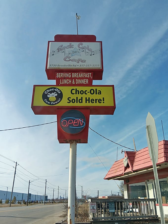 The sign promises three essential food groups—breakfast, lunch, and dinner—plus the legendary Choc-Ola that Grandpa still talks about.