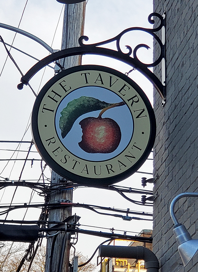The Tavern's hanging sign features their signature cherry logo—a simple fruit that represents a complex and delicious dining experience.