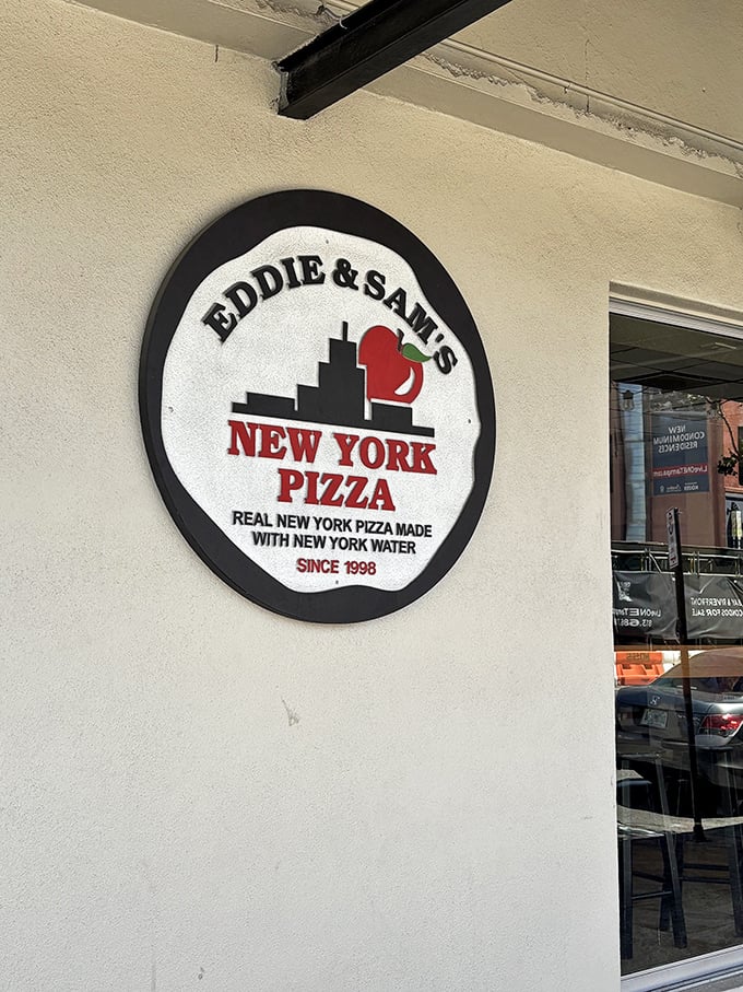 The logo says it all—"Real New York Pizza Made With New York Water." Some restaurants talk the talk; Eddie and Sam's ships in the proof.