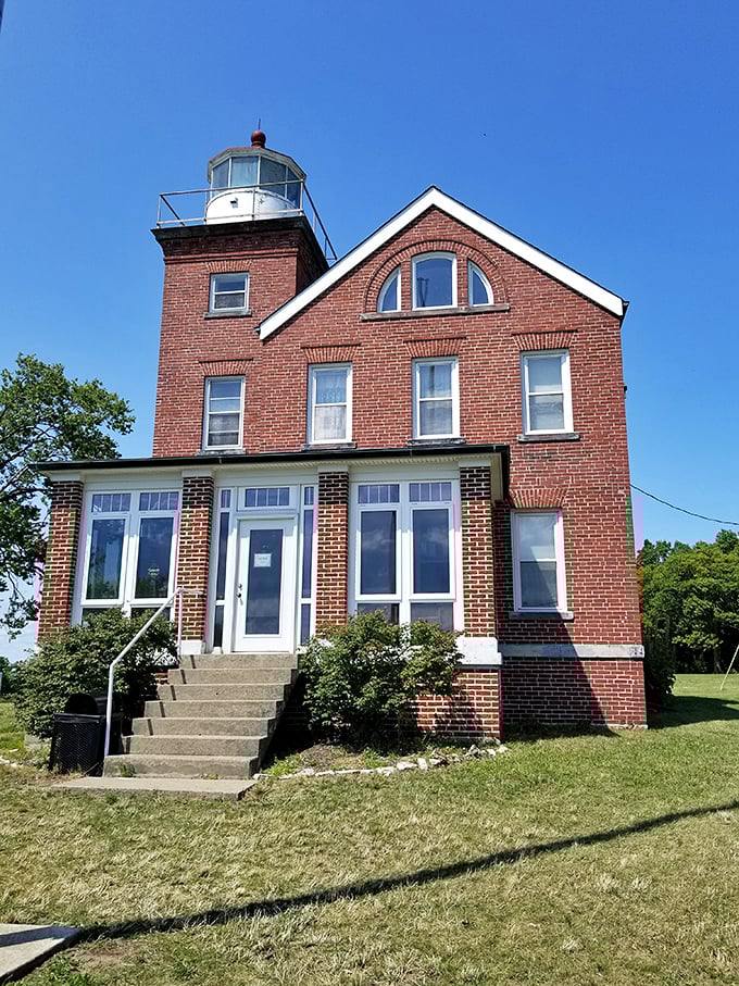 South Bass Island Lighthouse stands guard like a brick sentinel with windows, watching over mariners since 1897 with steadfast architectural dignity.