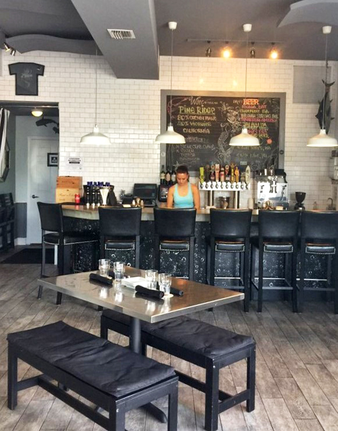 Where the magic happens. The bar's clean lines and chalkboard specials hint at the culinary creativity flowing from kitchen to table.