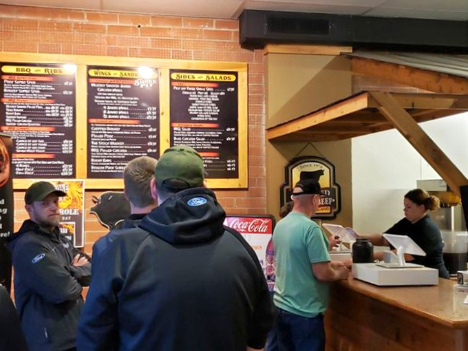 The ordering counter – where BBQ dreams begin and diet plans go to die. These folks are the gatekeepers to smoked meat paradise. 