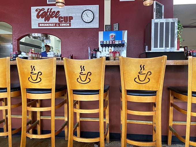 Wooden chairs with coffee cup cutouts tell you everything: this place takes its namesake seriously. The counter seats—always the choice of breakfast connoisseurs.