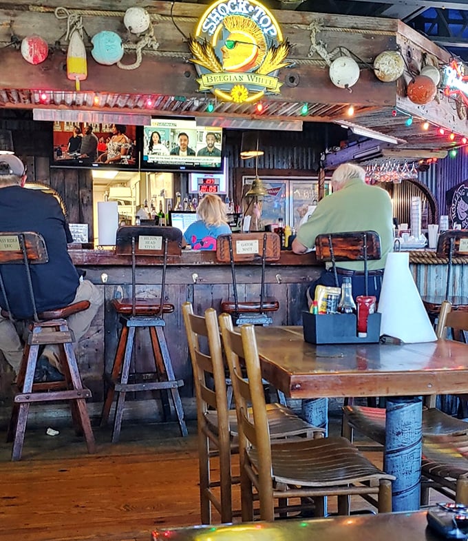 The bar's weathered wood tells stories of countless elbows, happy hours, and "just one more" moments that stretched into evening.