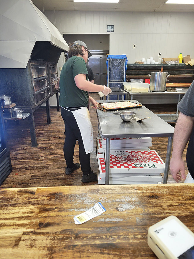 Behind the scenes where the magic happens – skilled hands preparing the next batch of rectangular perfection on well-worn wooden floors.