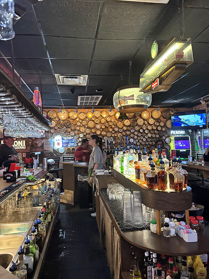 The bar area, where vintage clocks meet modern spirits. This isn't just where drinks are served—it's where strangers become friends over shared stories and Limoncello.
