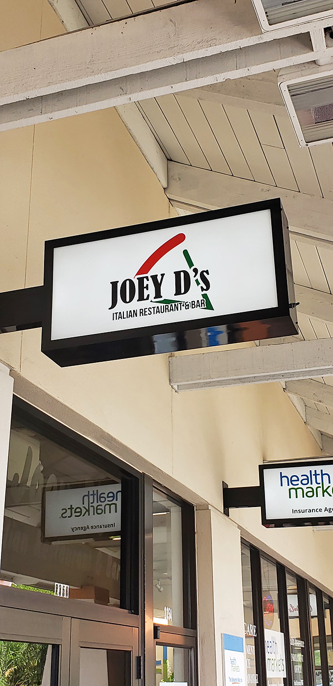 The sign that promises Italian delights within. That red and green logo is like a beacon for hungry souls seeking pasta salvation.