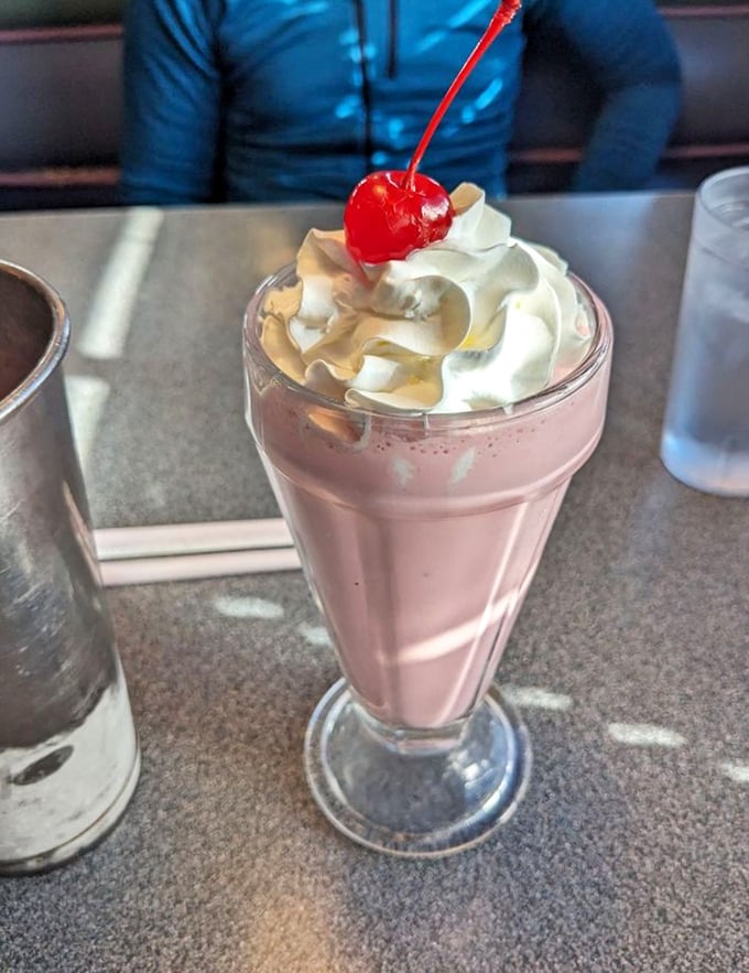 A strawberry milkshake topped with whipped cream and a cherry that's worth every mile of your journey and every calorie on your conscience.