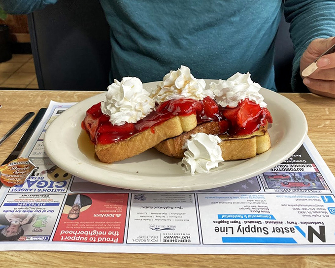 French toast that's had a glow-up – stuffed with goodness, crowned with strawberries and whipped cream, it's breakfast masquerading as dessert.