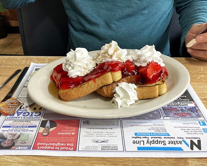 French toast that's had a glow-up – stuffed with goodness, crowned with strawberries and whipped cream, it's breakfast masquerading as dessert.