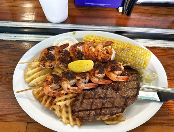 Surf meets turf in perfect harmony. Those blackened shrimp skewers alongside a perfectly grilled steak prove that you really can have it all.
