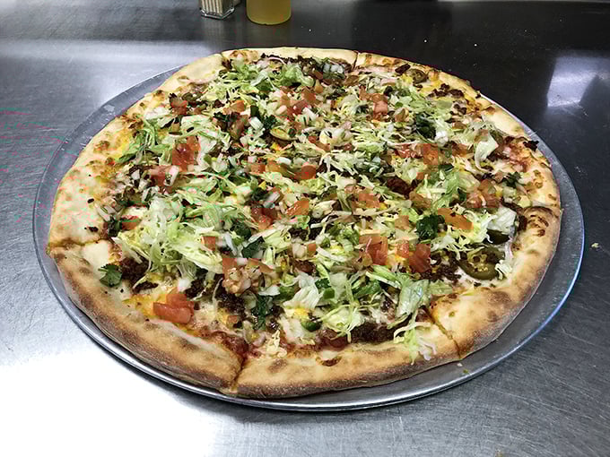 This isn't just any pizza—it's a garden on a crust. Fresh lettuce, tomatoes, and a rainbow of toppings create a feast for both eyes and stomach.