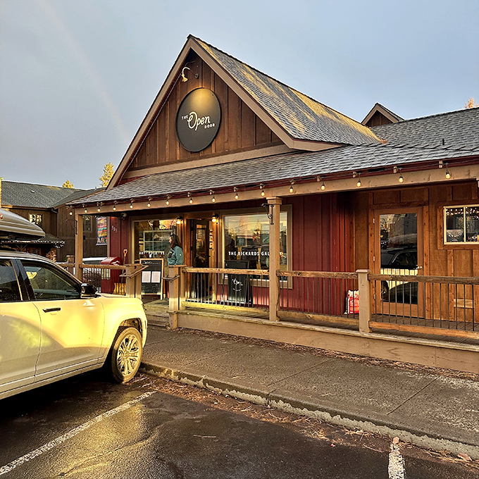 The Open Door's rustic-chic exterior catching golden hour light like it was designed for it. Those string lights aren't decoration—they're a promise of evening magic.