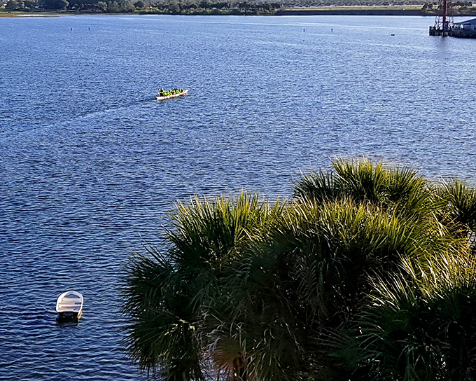 Reflections dance across calm waters as residents enjoy the boardwalk—a daily ritual that never loses its charm in this waterfront community.
