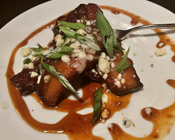 Thick-cut bacon glazed to mahogany perfection – proof that sometimes the appetizer can be just as memorable as the main course.