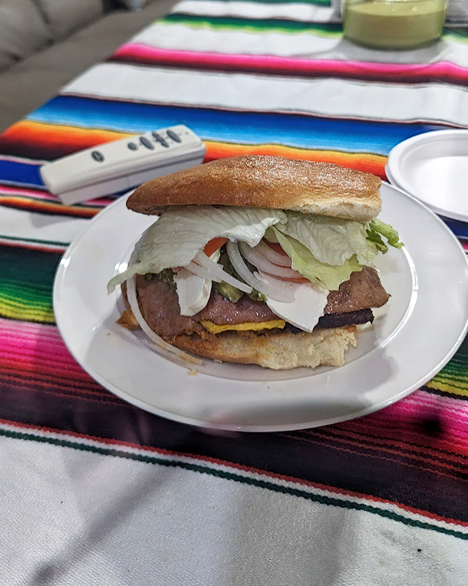 This torta asada isn't just a sandwich—it's an engineering marvel of textures and flavors stacked between bread that knows its purpose.