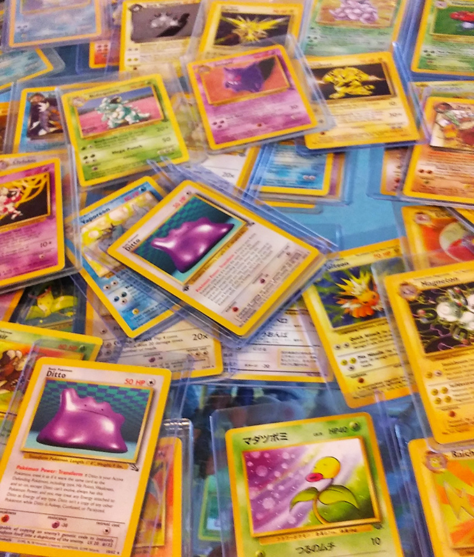 Pokémon cards spread like colorful confetti – each one a tiny piece of millennial childhood now worth more than anyone's parents ever imagined.