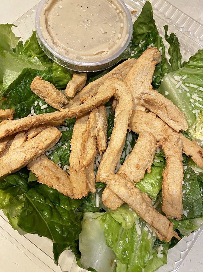 Even the salads at Gooey Looie's refuse to be dainty. Those crispy chicken strips have clearly been invited to a lettuce party.