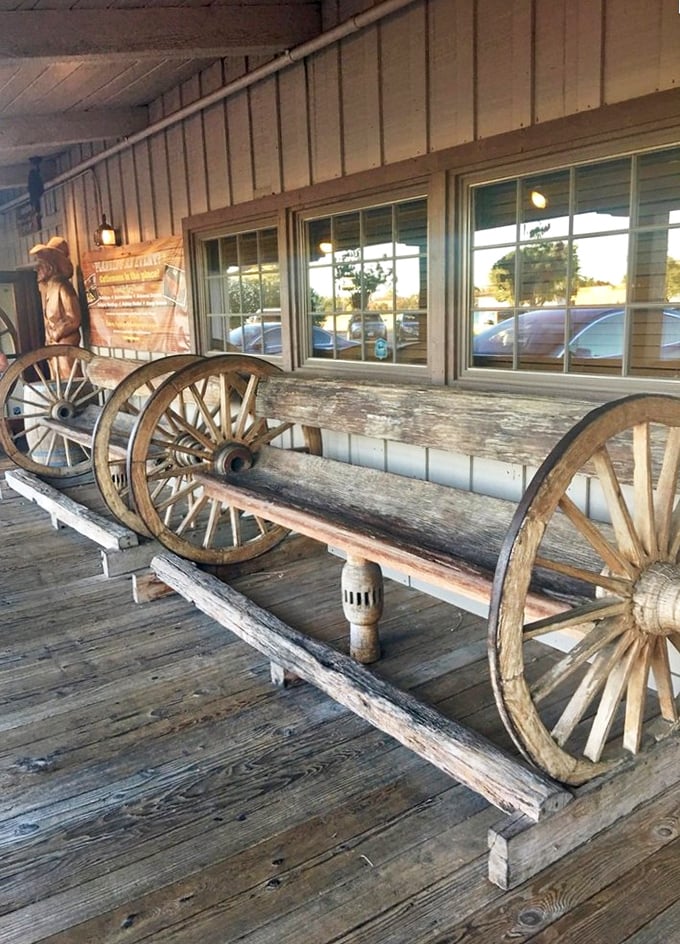 This wagon wheel bench isn't just for show—it's where hungry patrons contemplate life choices like "medium-rare or medium" while waiting.