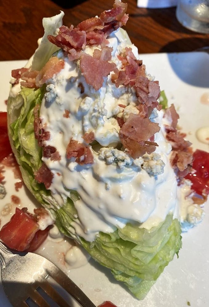 The wedge salad – America's brilliant solution to eating iceberg lettuce by smothering it with blue cheese and bacon. Democracy works!