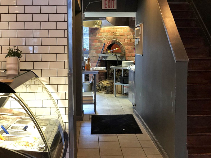 The heart of Vero—a wood-fired oven that transforms simple dough into blistered, bubbling masterpieces in just 90 seconds of fiery magic.