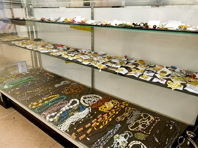 The jewelry counter gleams with possibility—vintage beads, contemporary pendants, and the occasional genuine gem hiding among costume treasures.