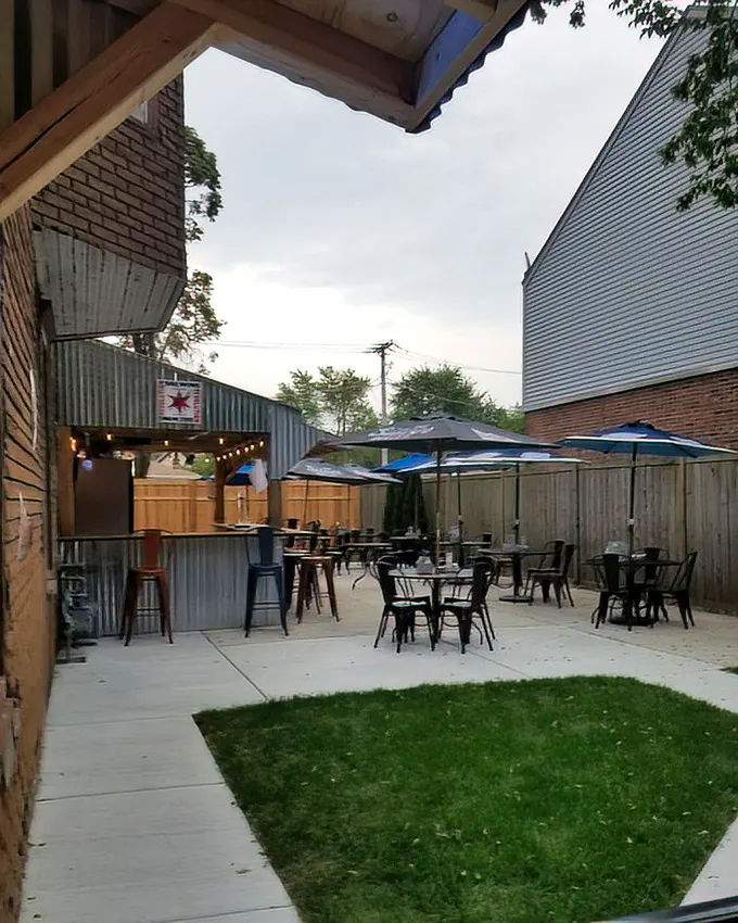 The back patio feels like your coolest friend's backyard—if your friend happened to serve legendary pizza instead of overcooked burgers.