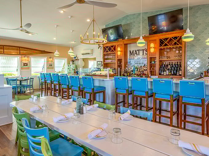 Bright blue chairs and coastal colors create a dining room that feels like a stylish friend's beach house—one where the friend happens to be an incredible chef.