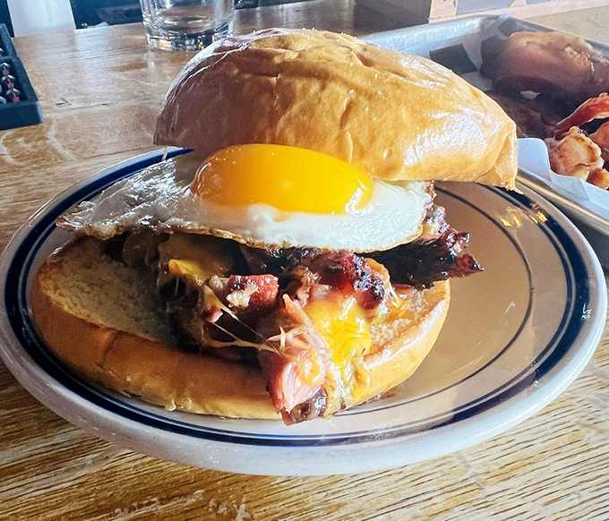 The breakfast sandwich that makes morning people out of night owls. Runny egg meets smoky meat on a soft bun—a sunrise symphony of flavors.