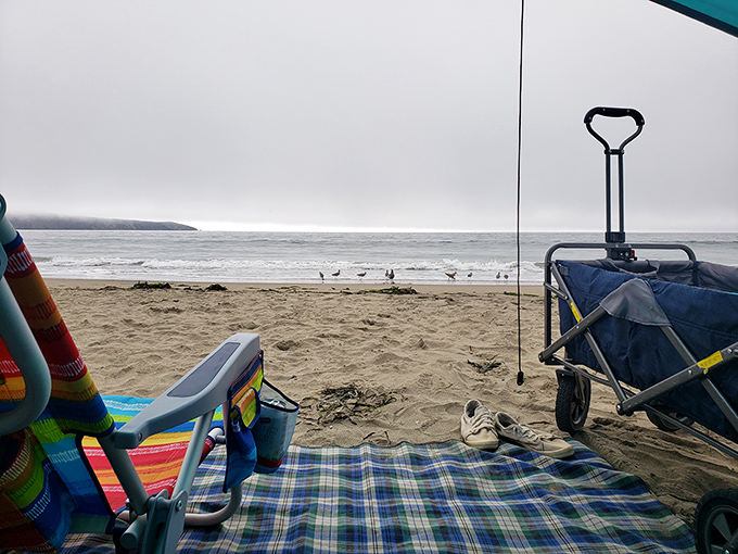 Beach day essentials: a colorful blanket, portable chairs, and absolutely no agenda more complicated than deciding when to reapply sunscreen.