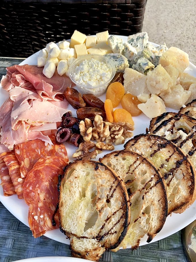 A charcuterie board that's basically a European vacation on a plate. Those grilled bread slices are the perfect vehicles for flavor.