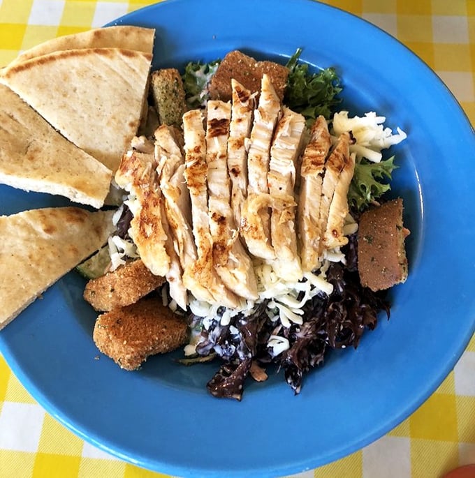 This chicken salad doesn't need fancy credentials—just perfectly grilled protein atop greens that weren't born in a plastic clamshell.