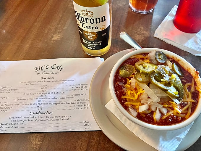 Zip's famous chili pairs beautifully with an ice-cold Corona. The menu waits patiently in the background, promising more delights for your next visit.