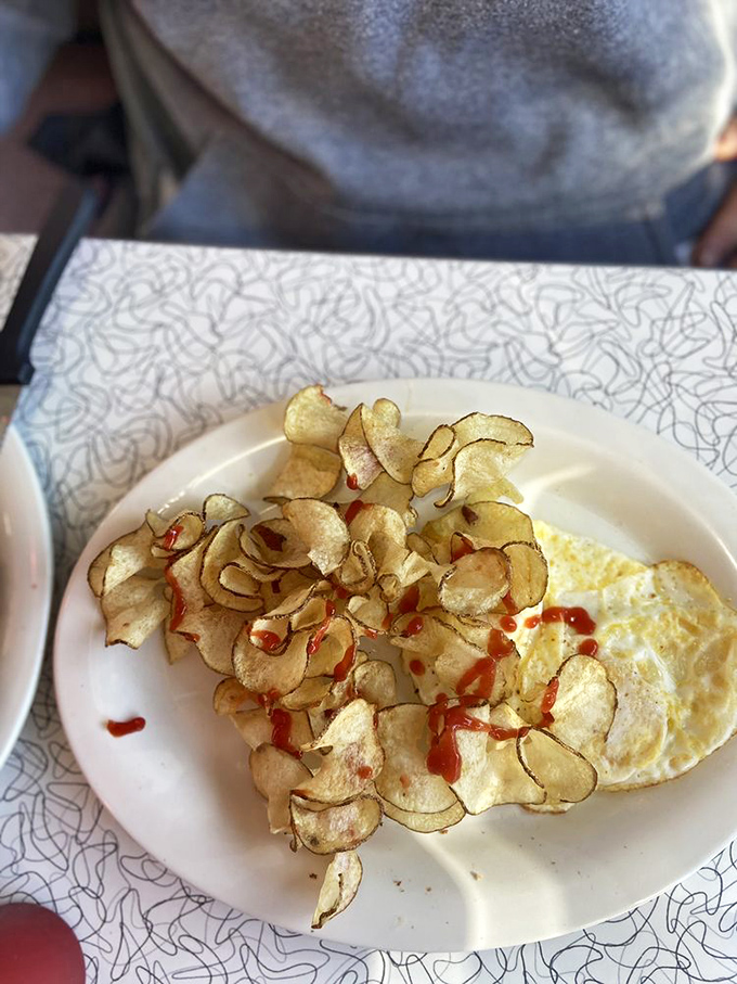 Homemade potato chips with a dash of hot sauce—proof that sometimes the simplest pleasures deliver the most profound satisfaction.