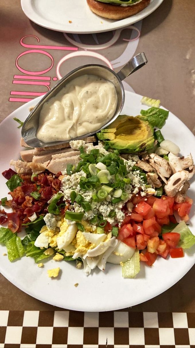 A Cobb salad that's practically a work of art – meticulously arranged ingredients waiting to be tossed into a symphony of flavors and textures.