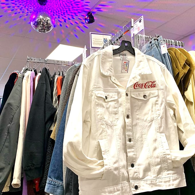That Coca-Cola jacket isn't just clothing – it's wearable nostalgia hanging beneath disco ball lighting that makes everyday shopping feel like an event.