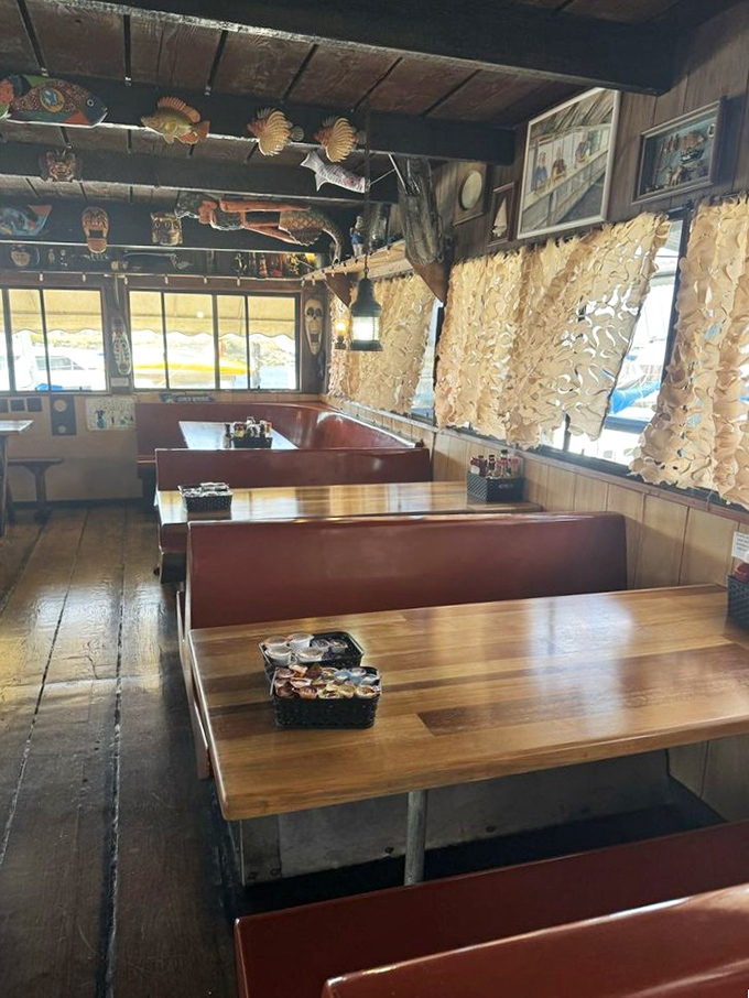 Booth seating that invites you to settle in and stay awhile. Those fish decorations overhead aren't just decor—they're setting expectations.