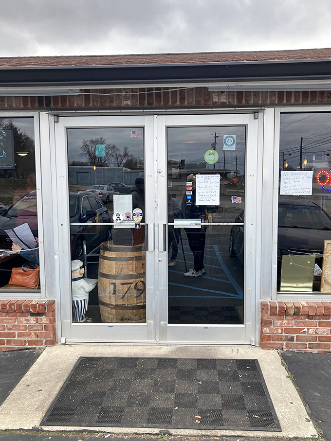 The entrance features a charming wooden barrel—a hint at the no-frills, unpretentious treasure trove of comfort food waiting inside.