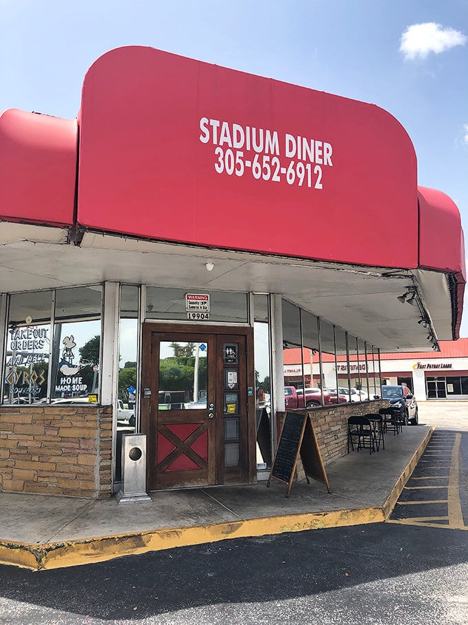 The entrance to flavor town—complete with stone facade, red door, and a sidewalk chalkboard promising homemade goodness that keeps locals coming back.