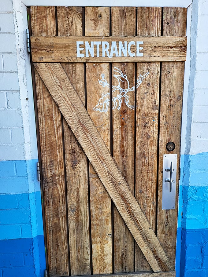 A wooden entrance door that wouldn't look out of place on a seaside shack in Maine. The lobster illustration hints at treasures within.
