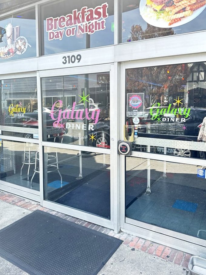 "Breakfast Day or Night" isn't just a slogan—it's a philosophy. The pink and green neon logos add a touch of cosmic whimsy.