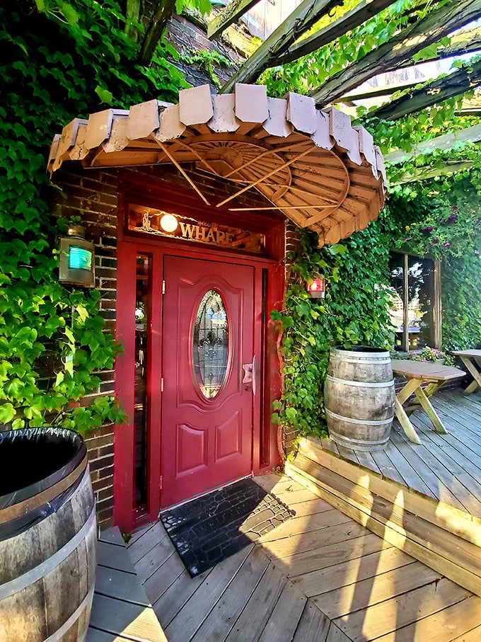 The red door promises adventure—like entering a secret garden where the treasure isn't gold doubloons but perfectly prepared seafood instead.