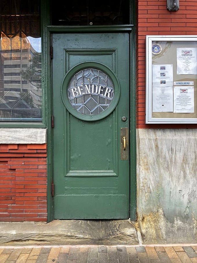 The green door with its etched glass window doesn't just mark an entrance—it's a portal to a time when dining was an event and restaurants were institutions. 