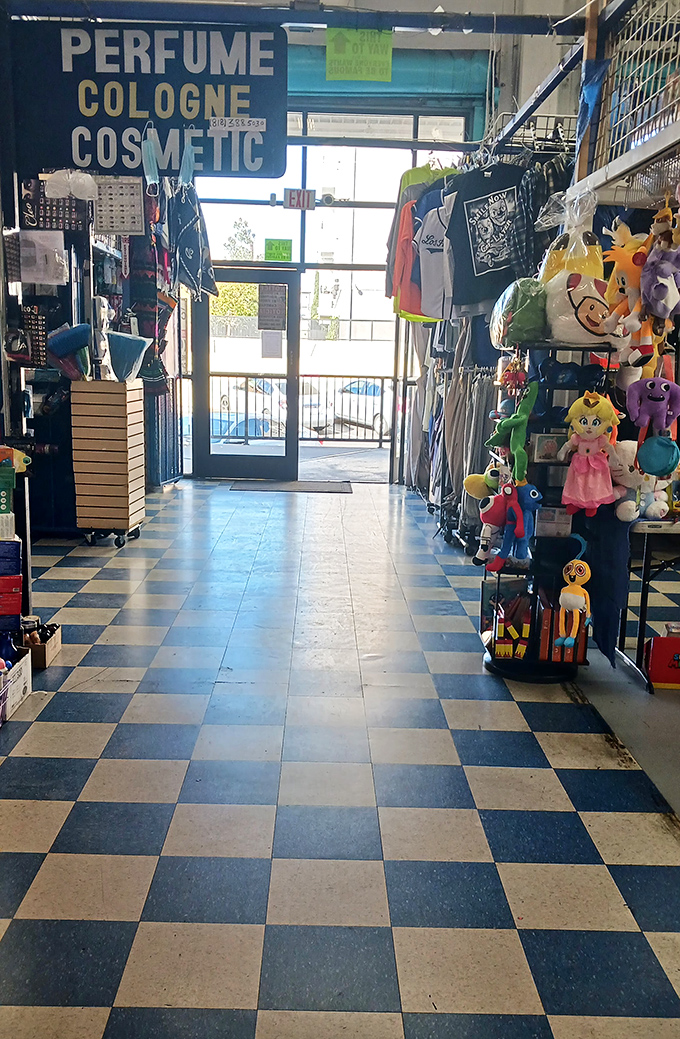 An exit framed by the perfume and cosmetics section. That light at the end of the tunnel? It’s the glow of last-minute temptations.