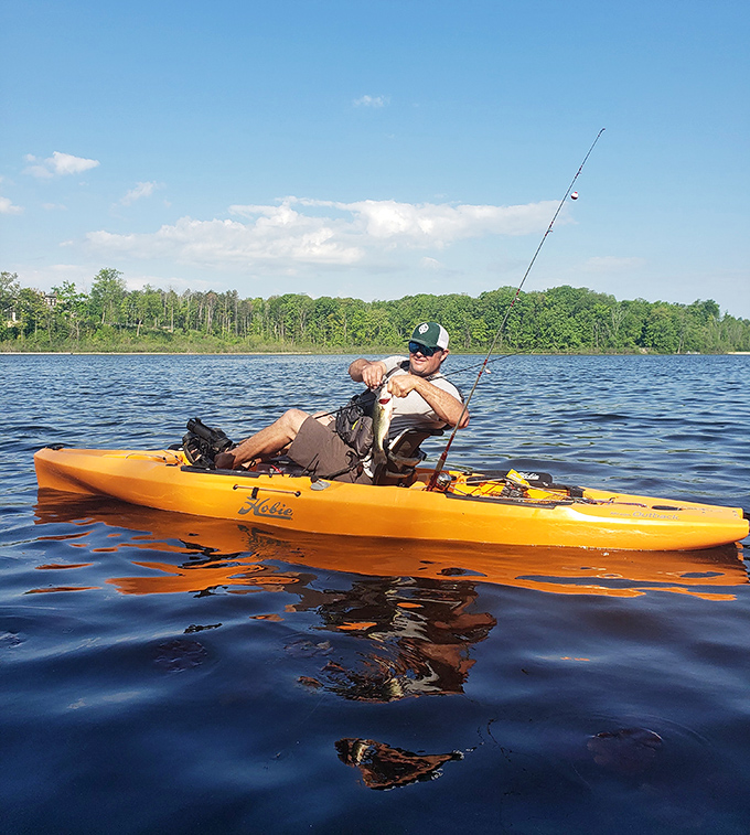 Fishing from a kayak—combining two great outdoor activities into one perfect package. That smile says "dinner's on me tonight!"