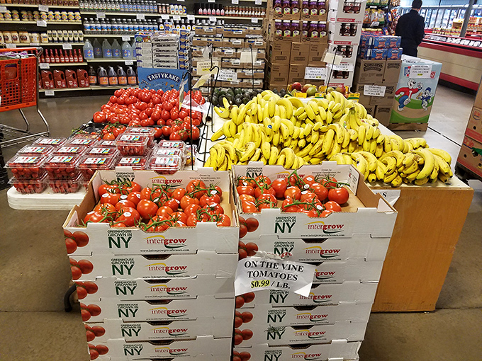 Tomatoes on the vine and bananas by the bunch—fresh produce displayed with no-nonsense practicality and priced for everyday enjoyment.