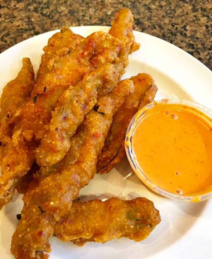 Fried okra that solves the eternal Southern dilemma: crispy exterior, tender interior, and not a hint of the dreaded slime. Victory in vegetable form. 
