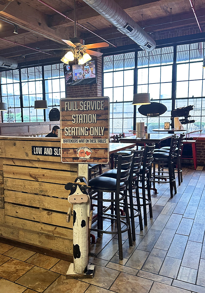 "Full Service Station" seating area combines industrial charm with BBQ functionality—where serious meat consumption is treated with proper respect.