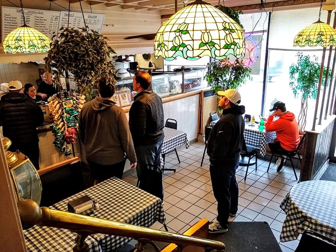 Tiffany lamps cast a warm glow over checkered tablecloths, creating an atmosphere where calories don't count and diet plans go to die.